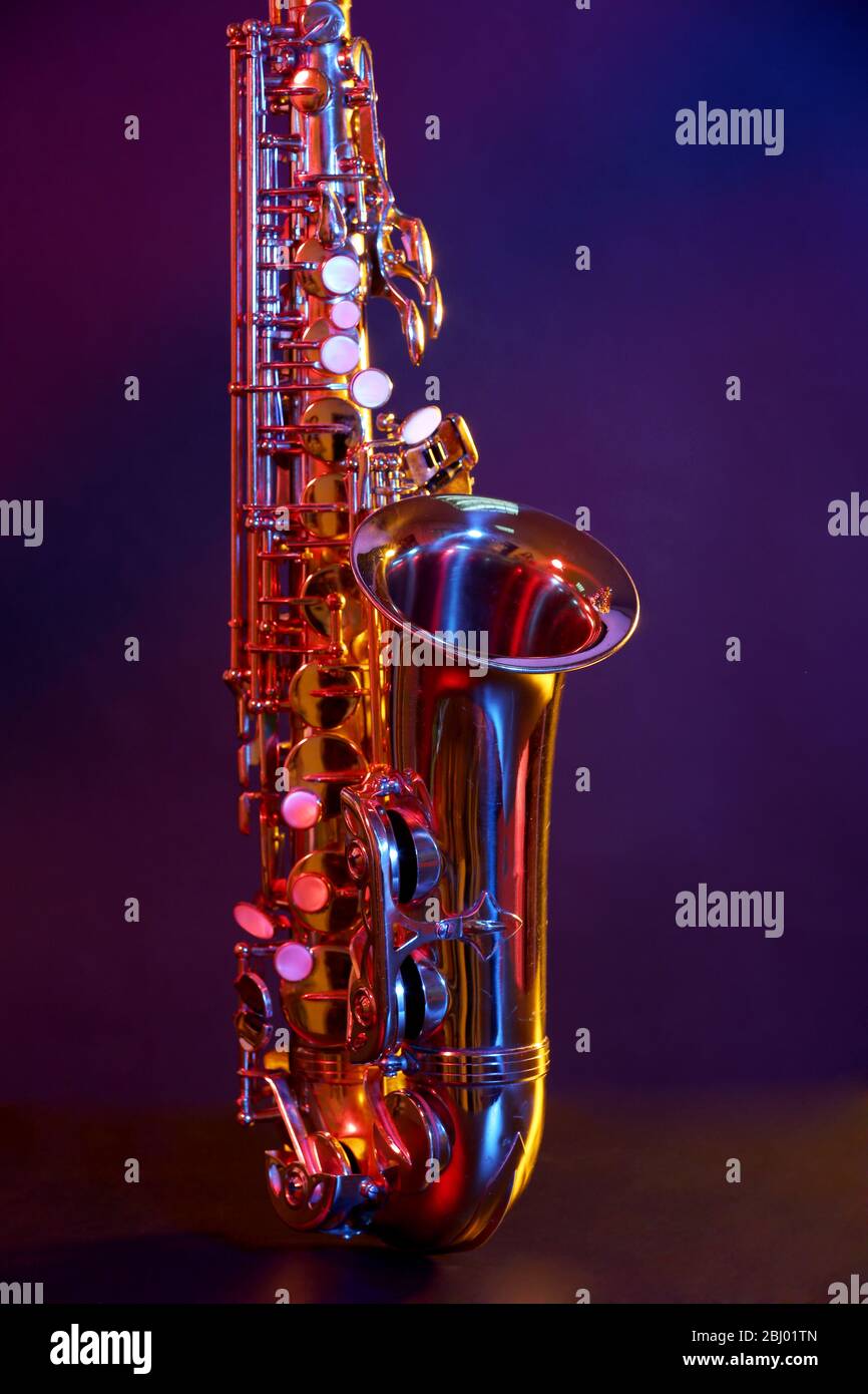 Golden saxophone on purple background Stock Photo - Alamy