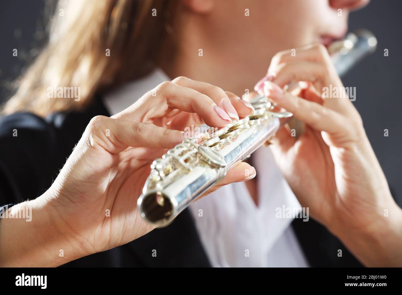 Musician playing flute, closeup Stock Photo - Alamy