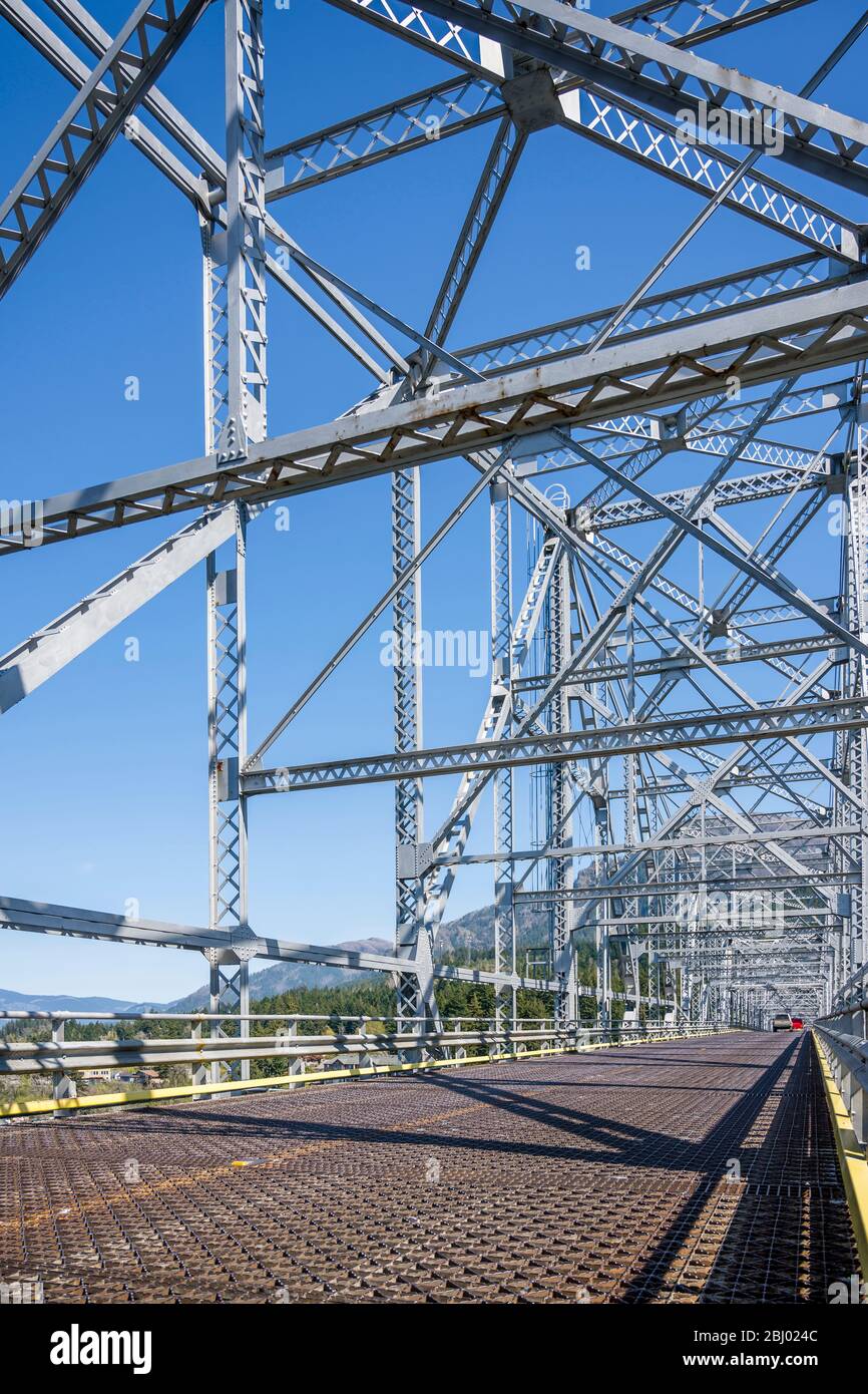 A silver color transportation open work metal truss bridge over the ...
