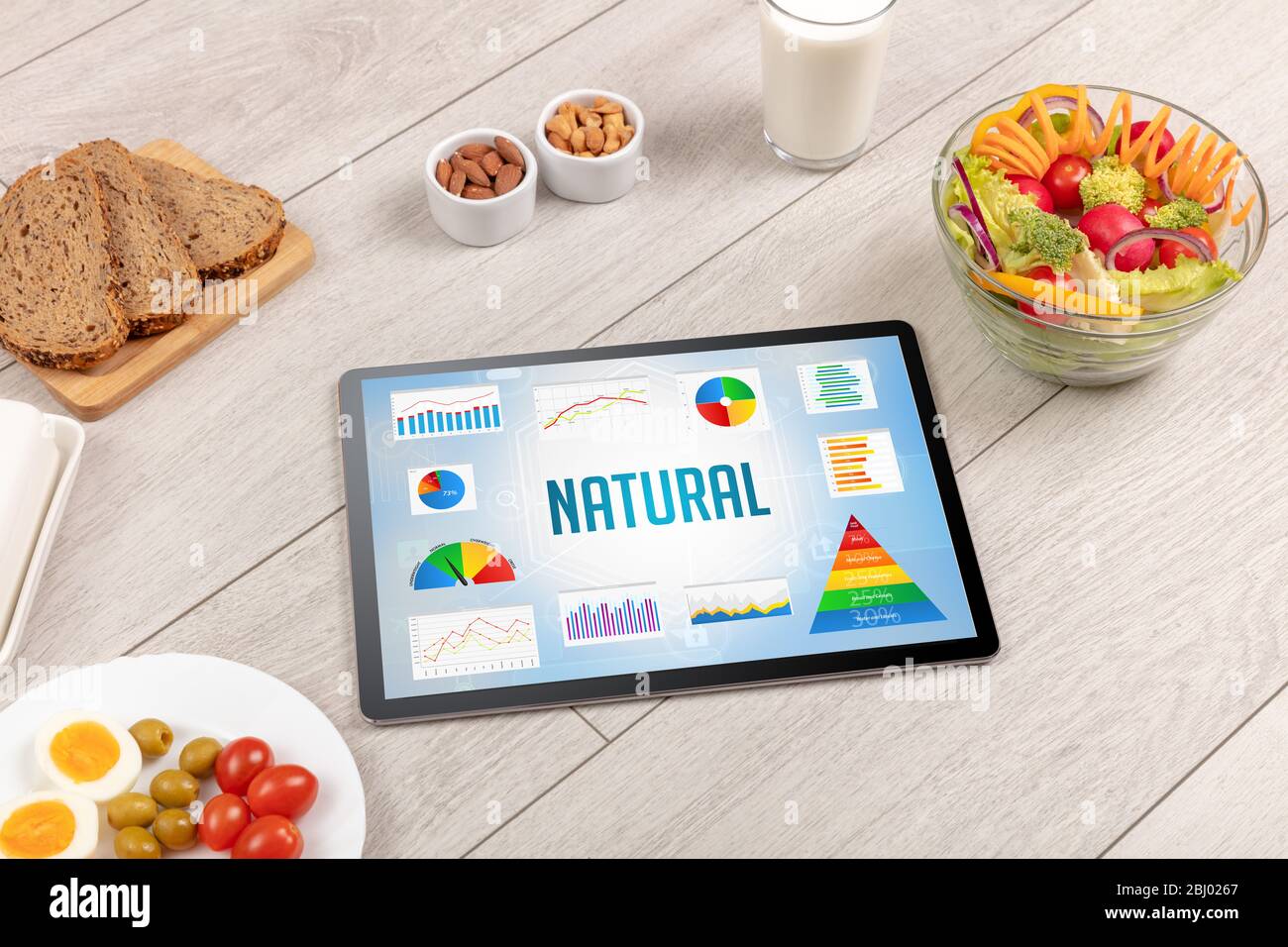 Organic food and tablet pc showing NATURAL inscription, healthy ...
