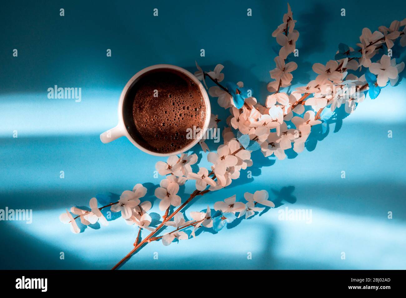 Coffee and spring flowers on blue background. Good mood concept. Blue ...