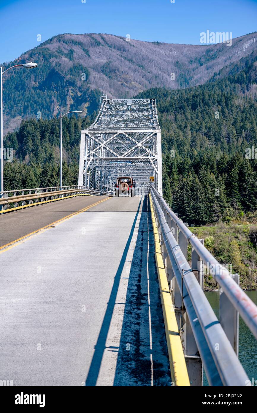 A silver color transportation open work metal truss bridge over the ...