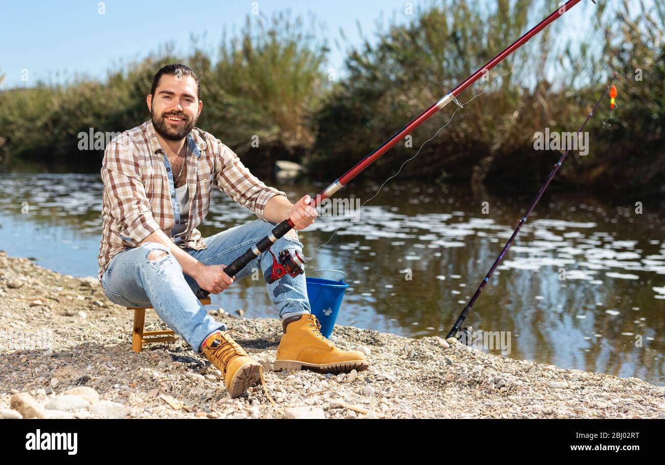 Bearded fisherman fishing on weekend in the river Stock Photo - Alamy