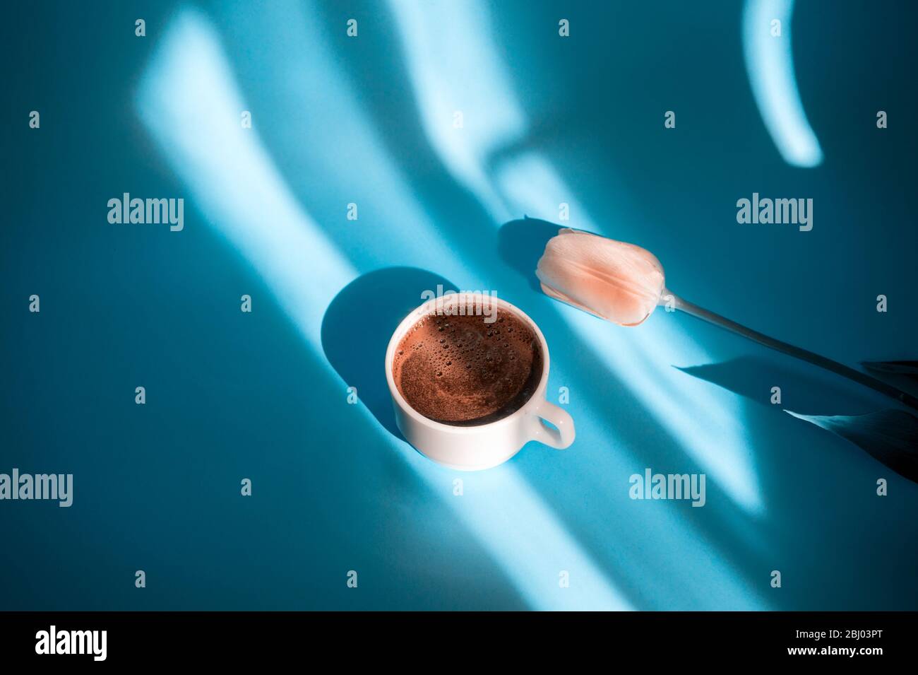 Coffee and spring flowers on blue background. Good mood concept. Blue ...