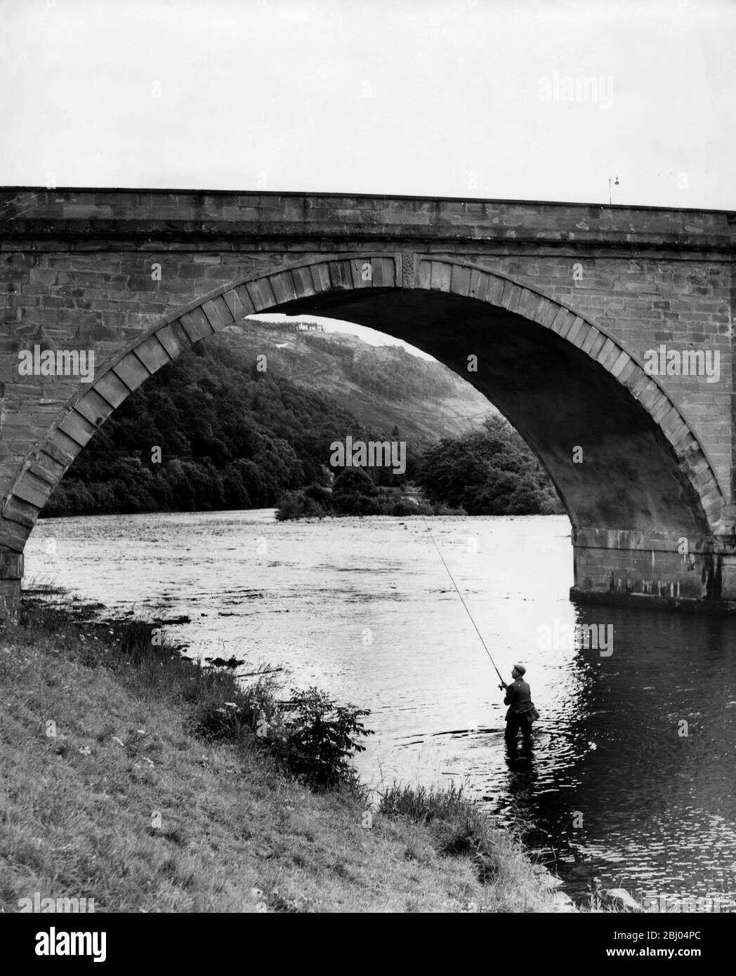 Angler - a fisherman who angles with rod Stock Photo - Alamy