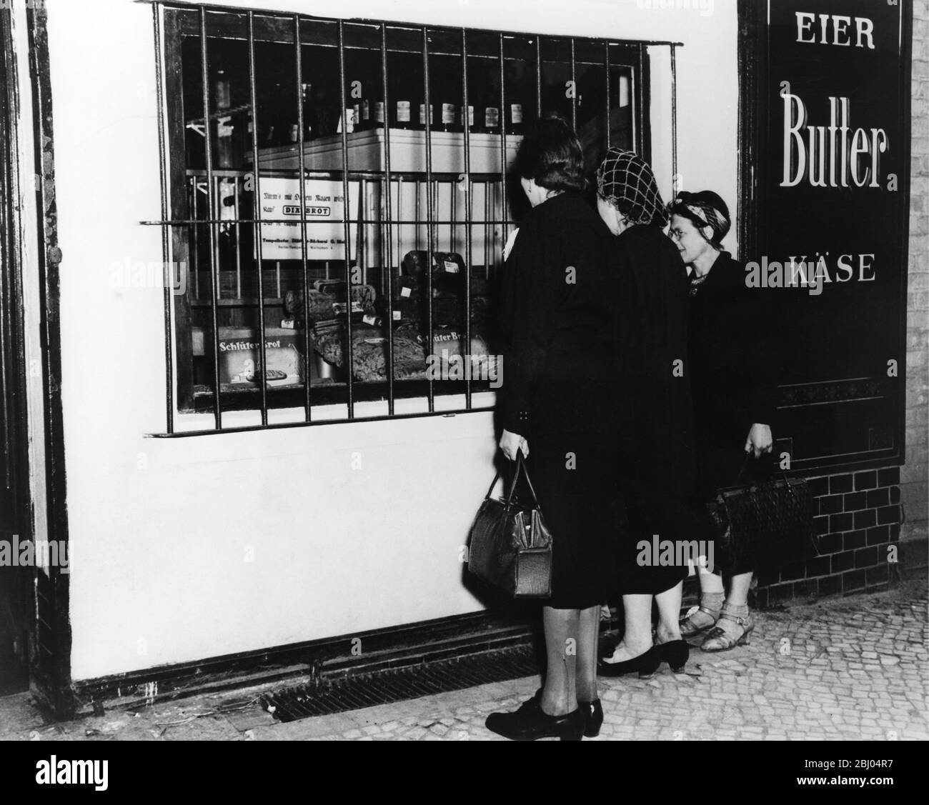 German women looking at the Air Lift bread in a grocery shop window ...