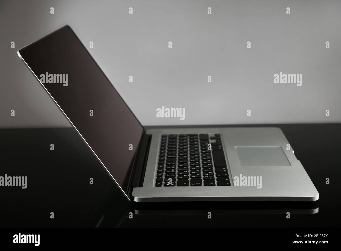 Laptop on gray background Stock Photo - Alamy