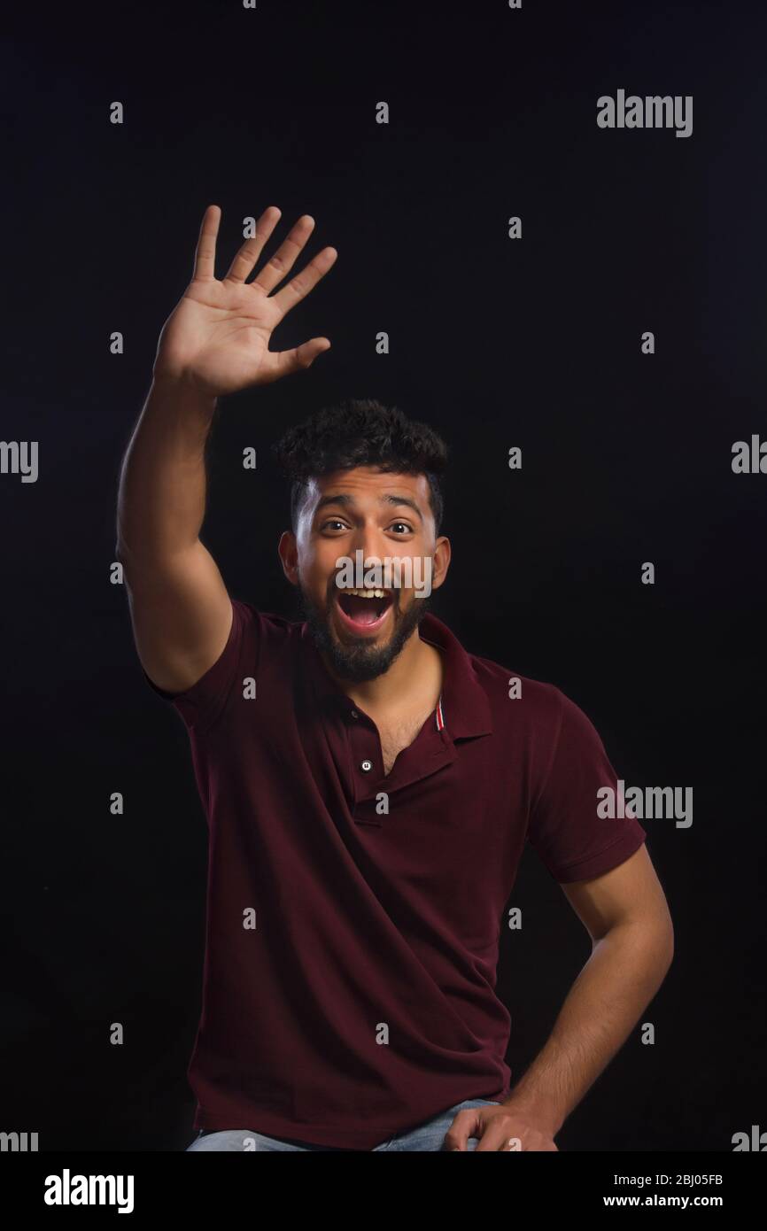 Young man waving in excitement Stock Photo - Alamy
