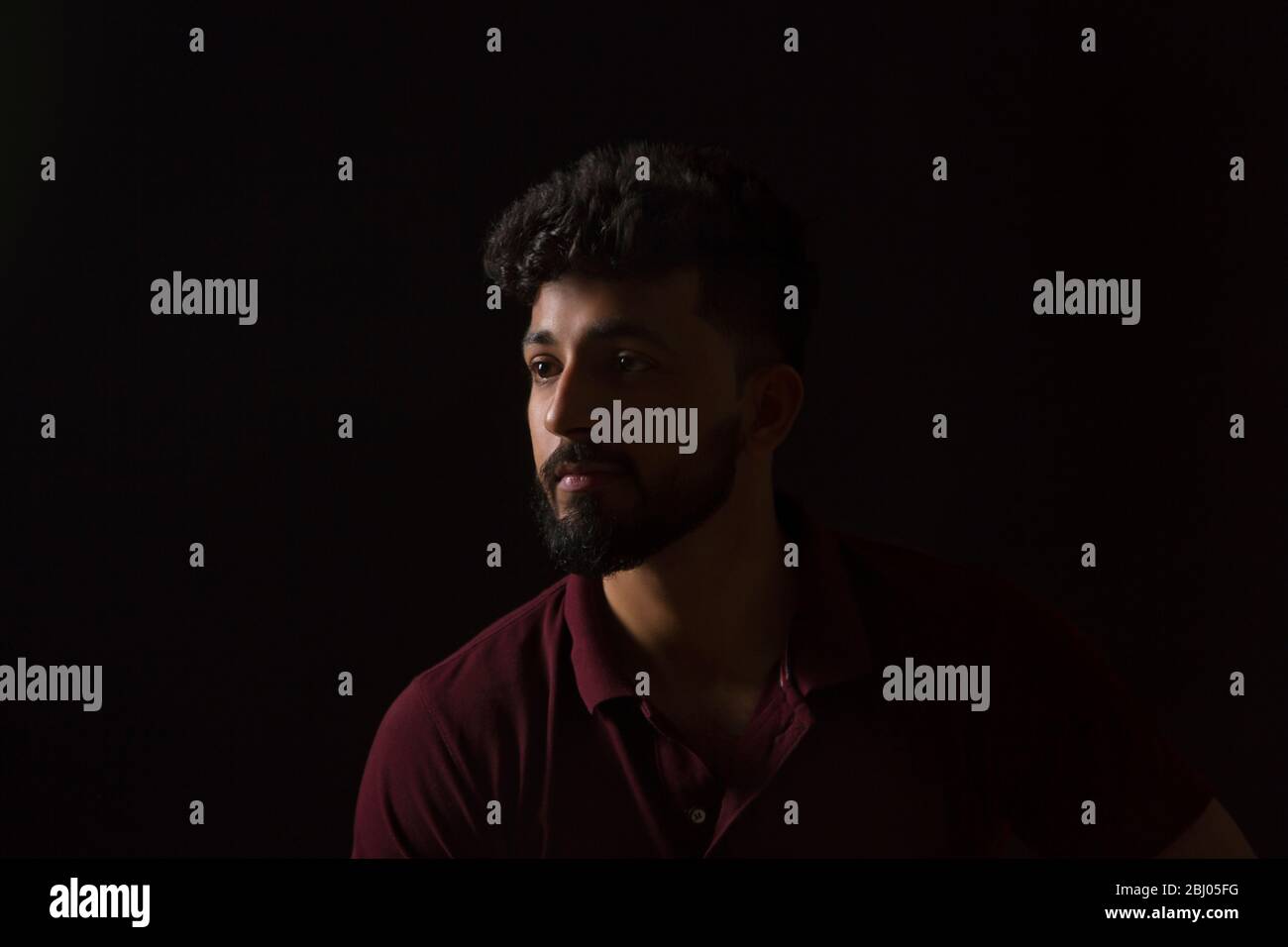 Sad man sitting in dark hi-res stock photography and images - Alamy