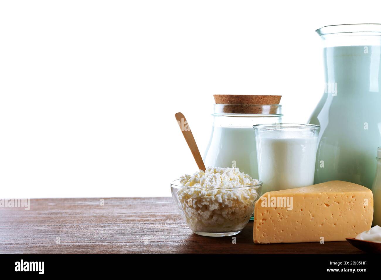 Dairy products on wooden table on white background Stock Photo - Alamy