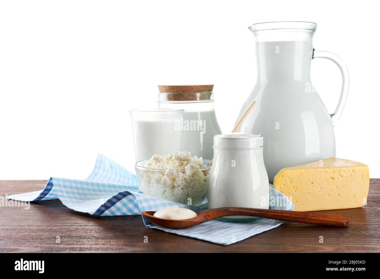 Dairy products on wooden table on white background Stock Photo - Alamy