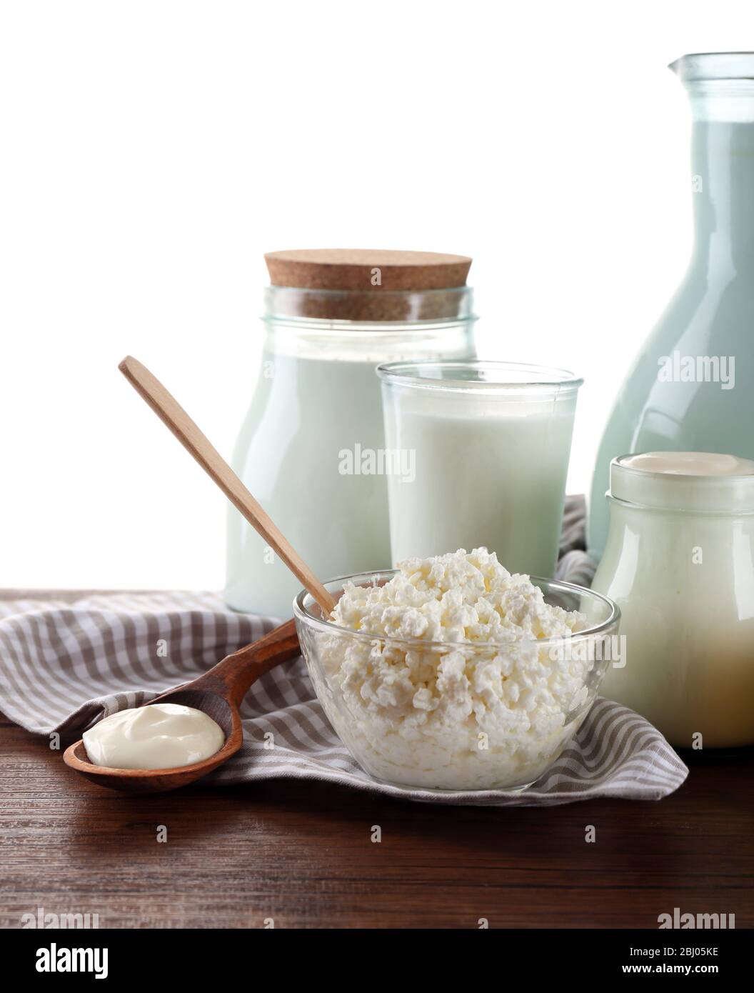 Dairy products on wooden table on white background Stock Photo - Alamy