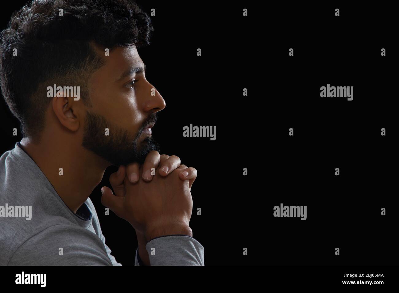 Young sad man praying hi-res stock photography and images - Alamy