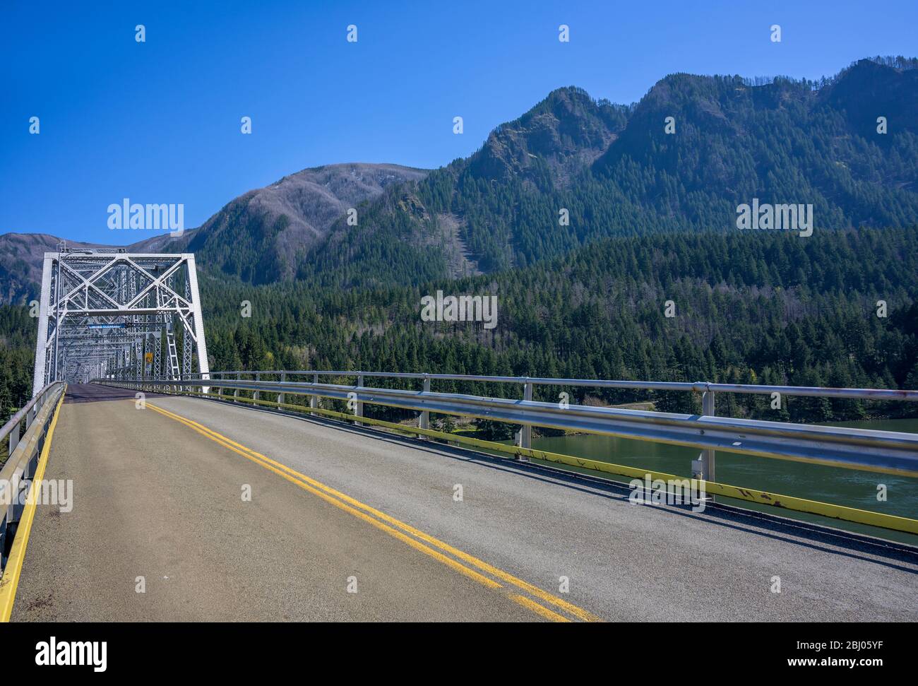 A silver color transportation open work metal truss bridge over the ...