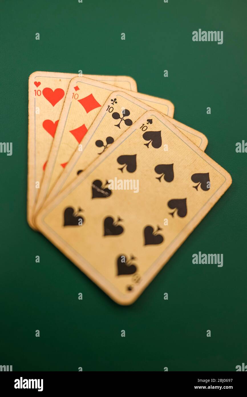 Playing cards on a green background Stock Photo - Alamy