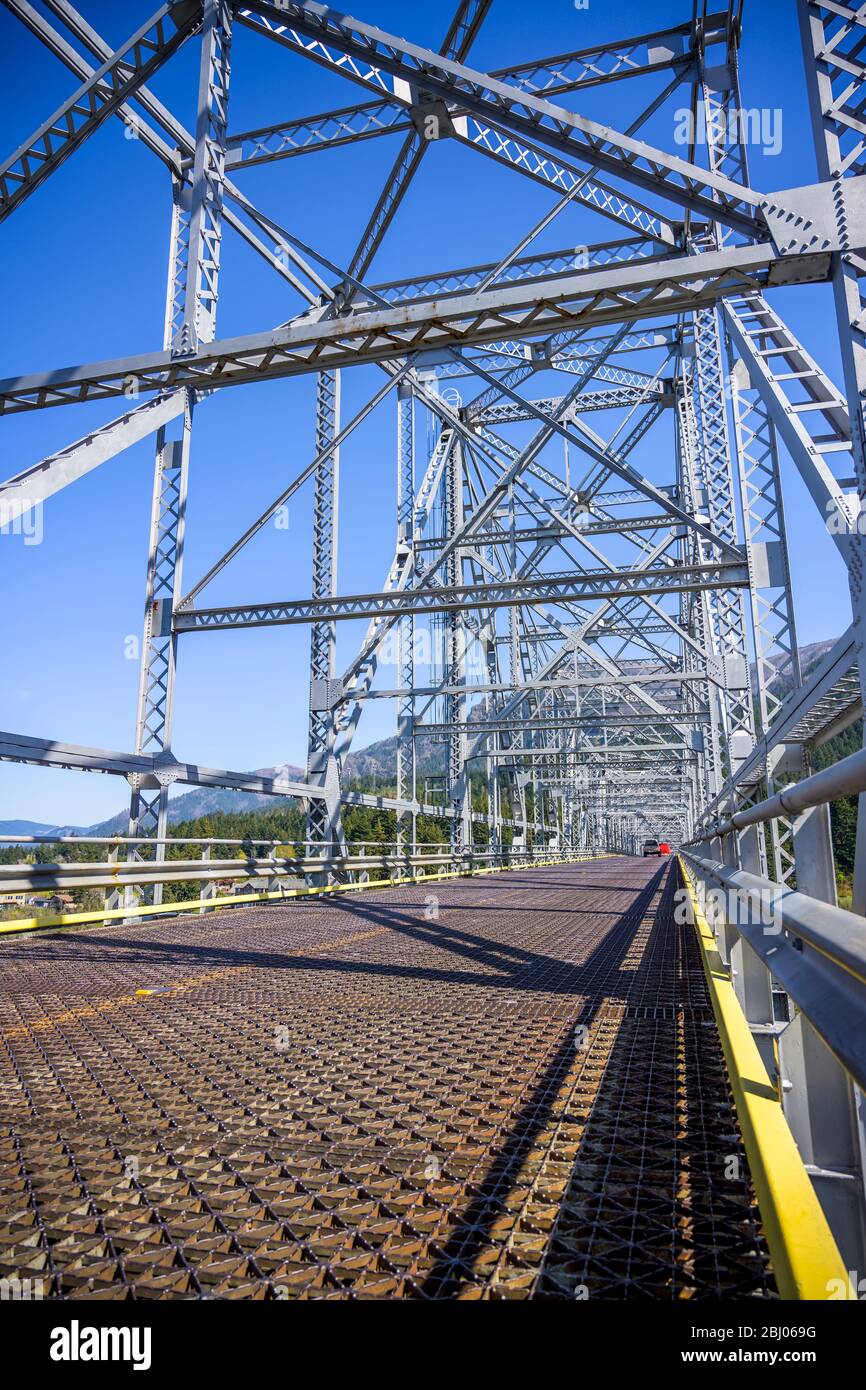 A silver color transportation open work metal truss bridge over the ...