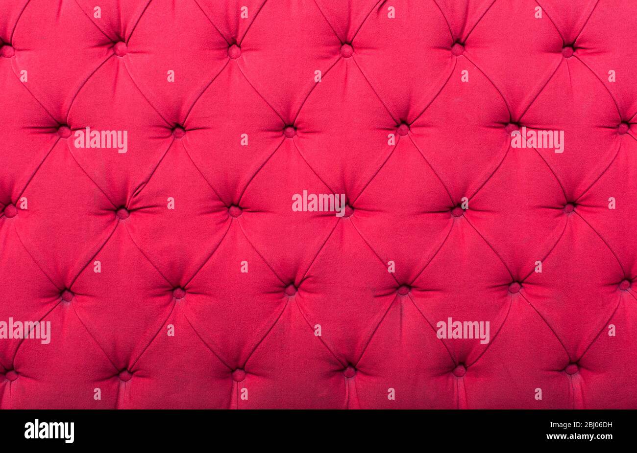 Close up view on bright pink textile texture of sofa Stock Photo - Alamy