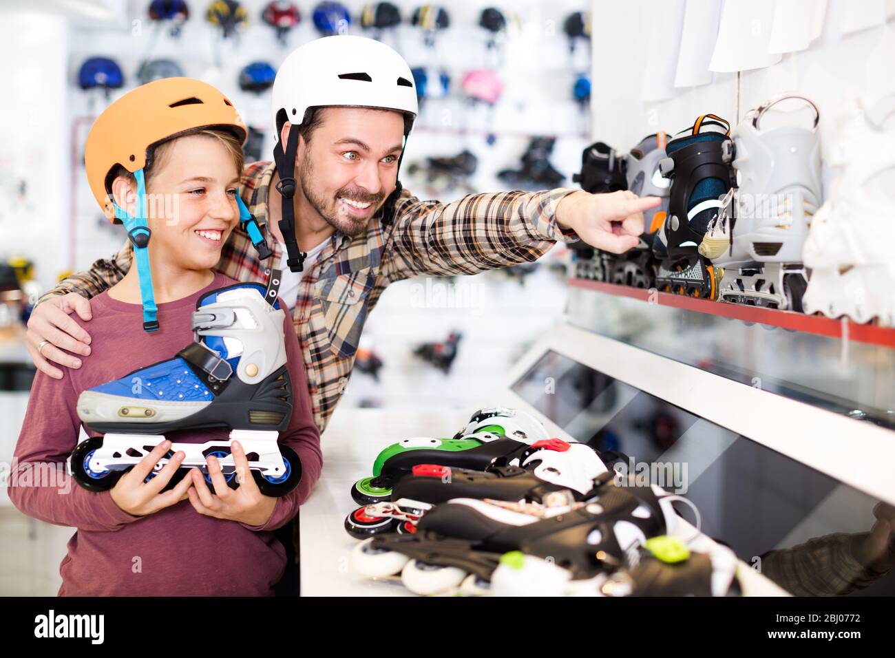 Smiling two people show to each other the design roller-skates Stock ...