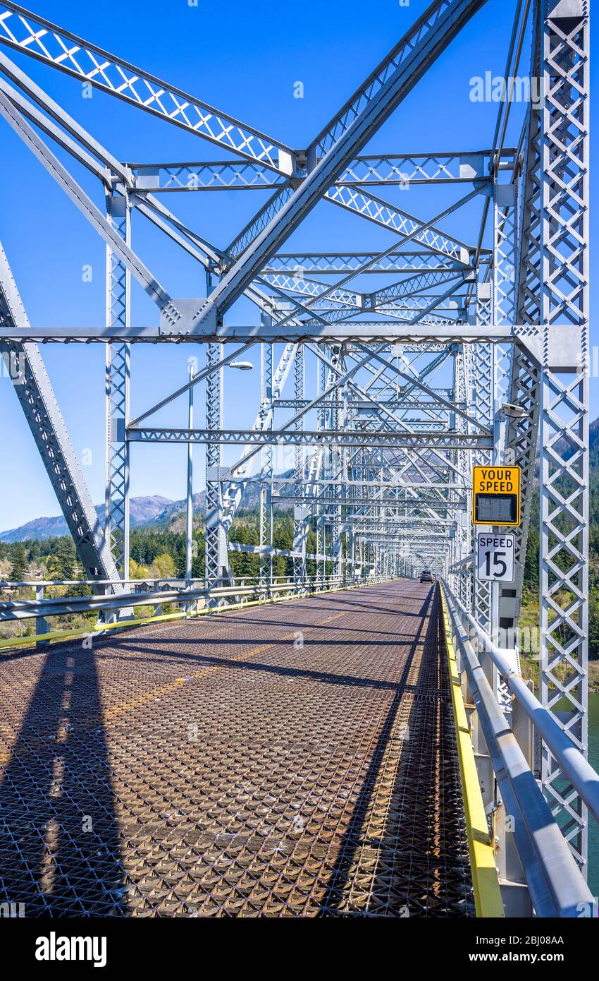 A silver color transportation open work metal truss bridge over the ...