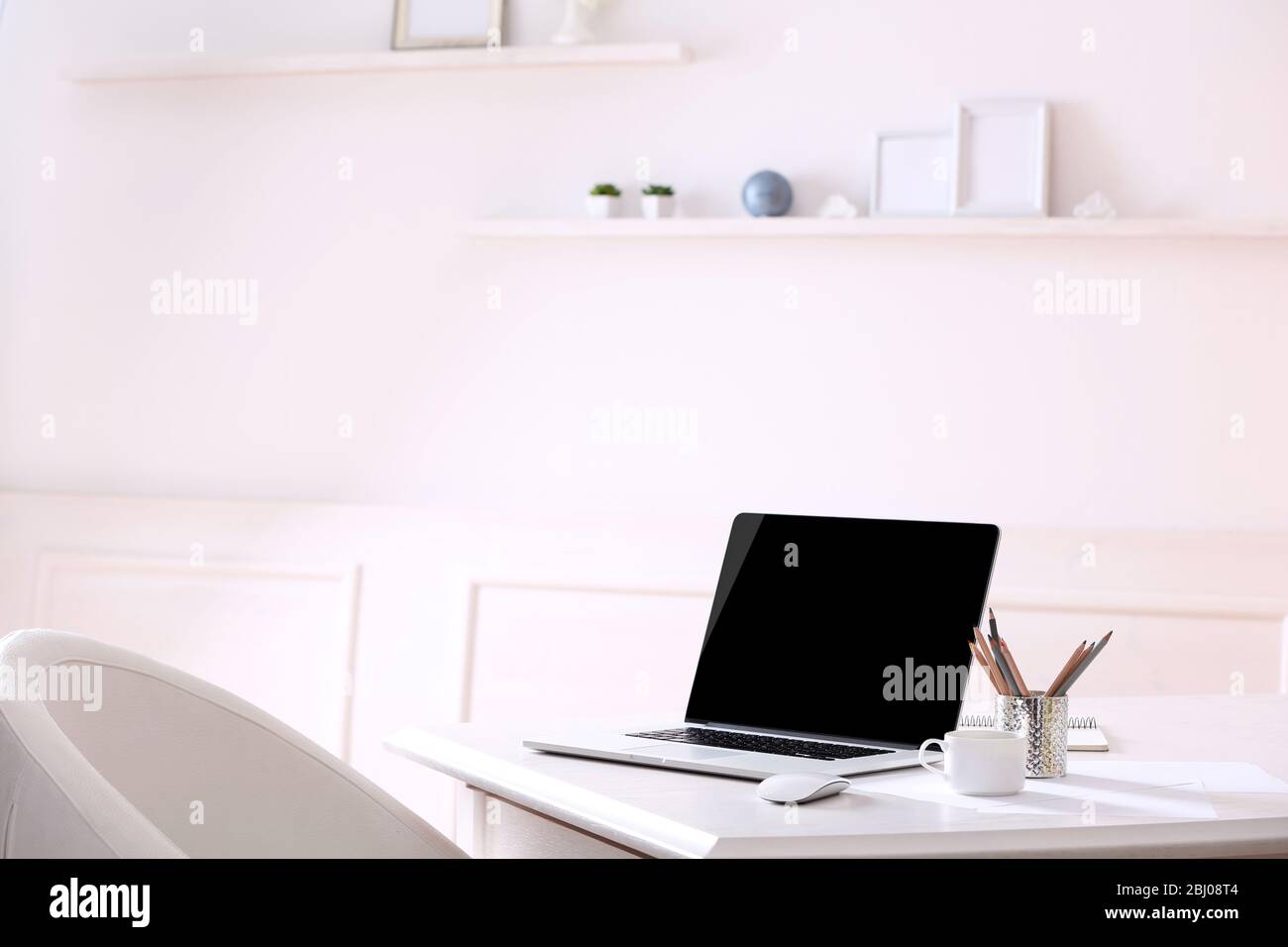 Workplace with laptop in room Stock Photo - Alamy