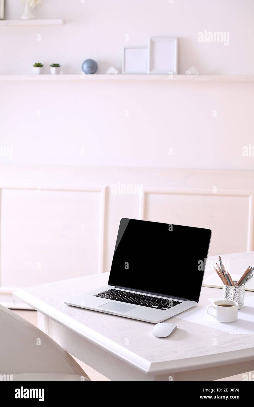 Workplace with laptop in room Stock Photo - Alamy
