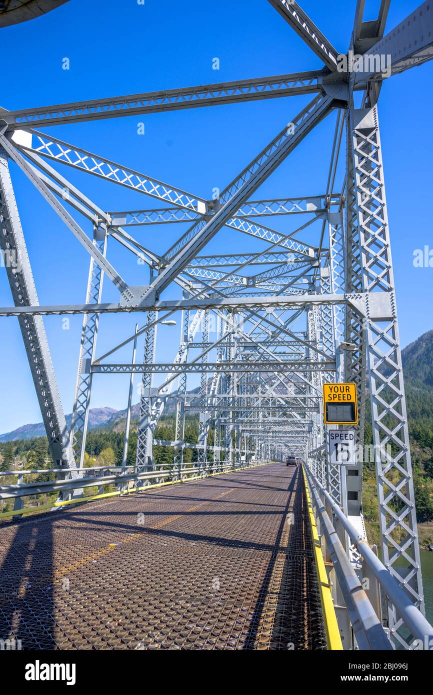 A silver color transportation open work metal truss bridge over the ...