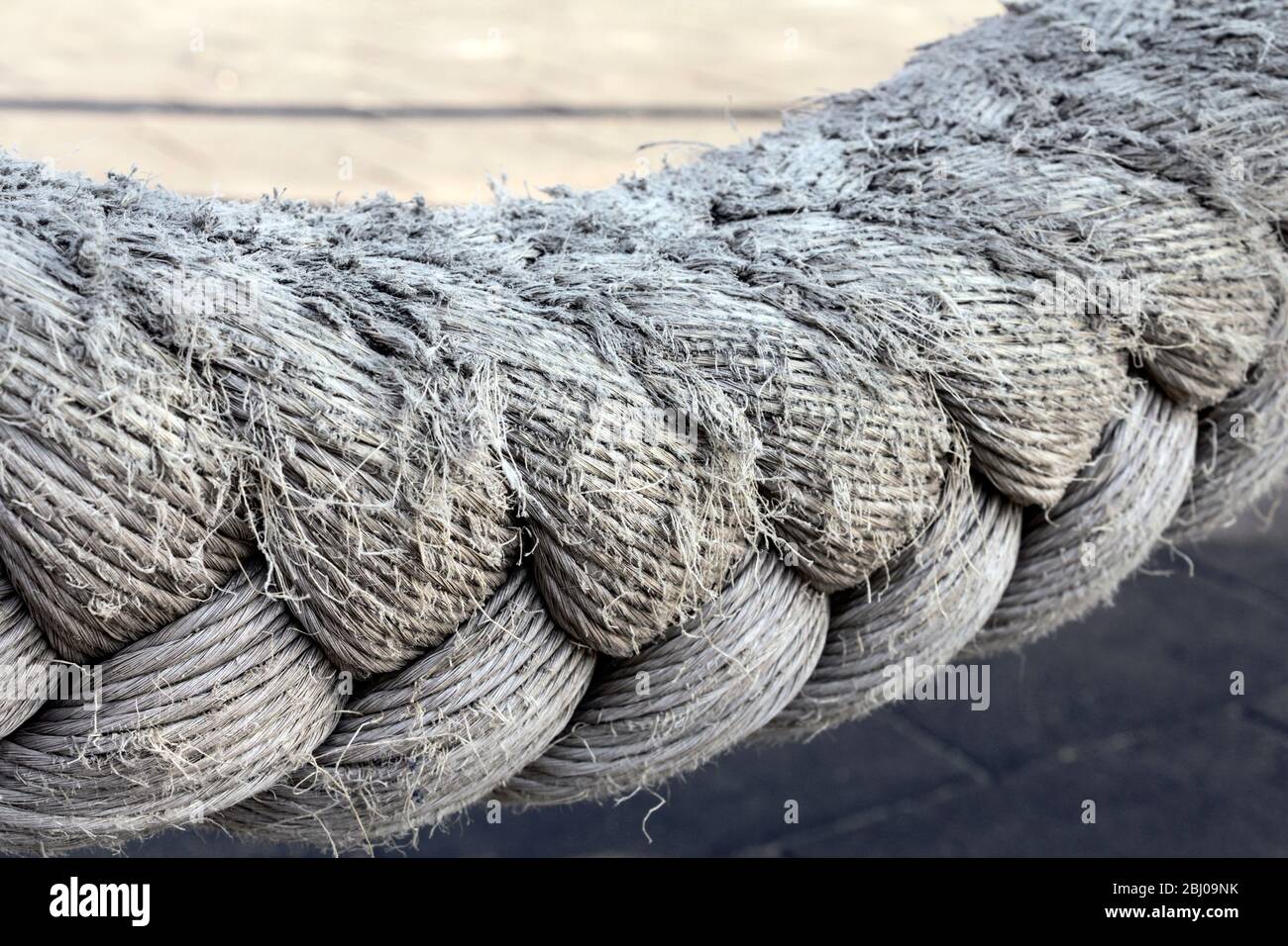 Close up of a strong rope hanging in the air, horizontally adividing ...