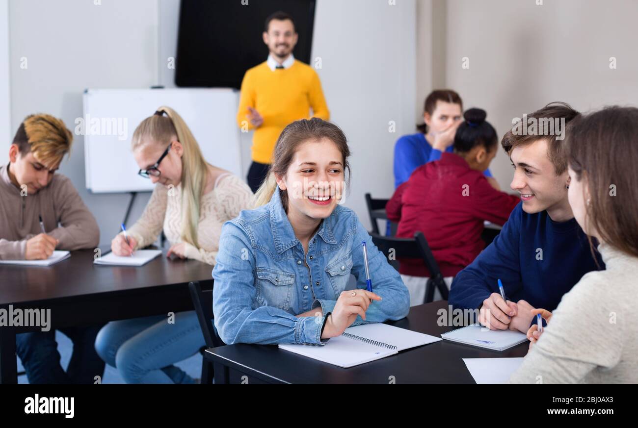 Smiling fellow students having group work tasks during school day Stock ...