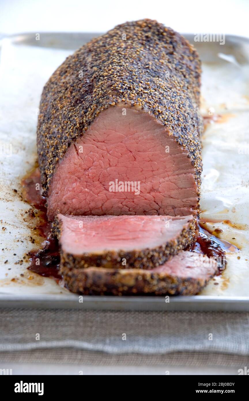 Roast fillet of beef with pepper coating in roasting tin Stock Photo ...