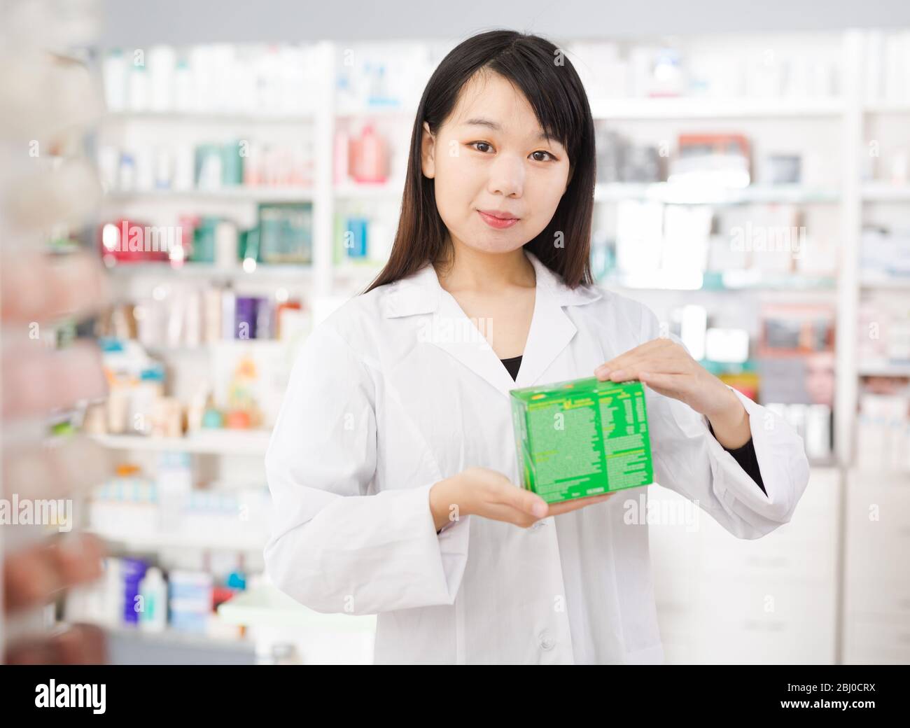 Chinese female pharmacist demonstrating assortment of pharmacy Stock ...