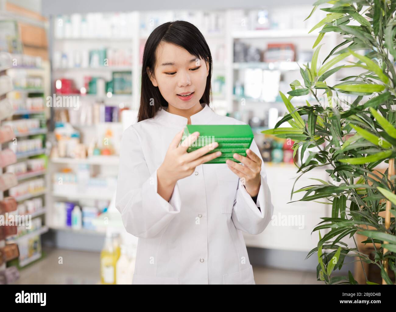 Chinese female pharmacist demonstrating assortment of pharmacy Stock ...