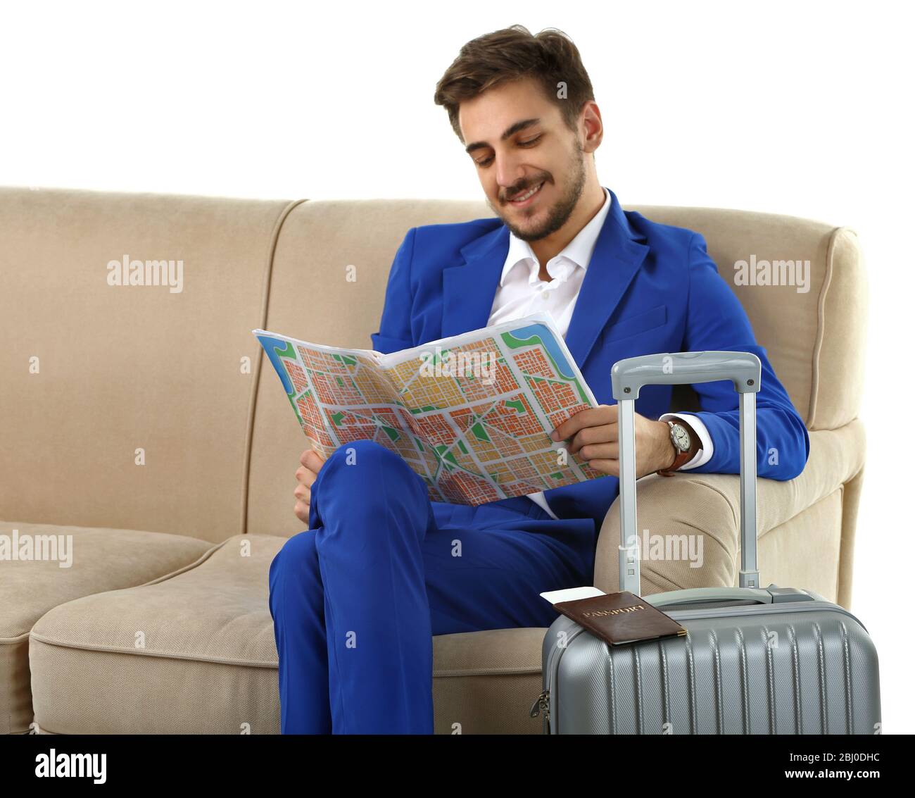 Business man with suitcase sitting on sofa isolated on white Stock ...