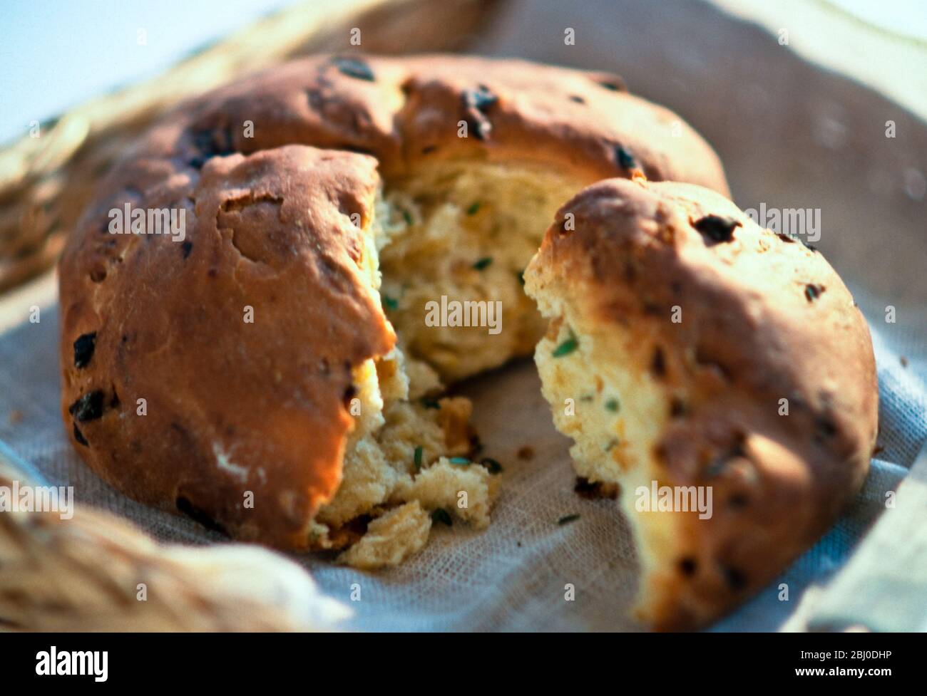 Home made herb and olive bread broken into quarters Stock Photo - Alamy