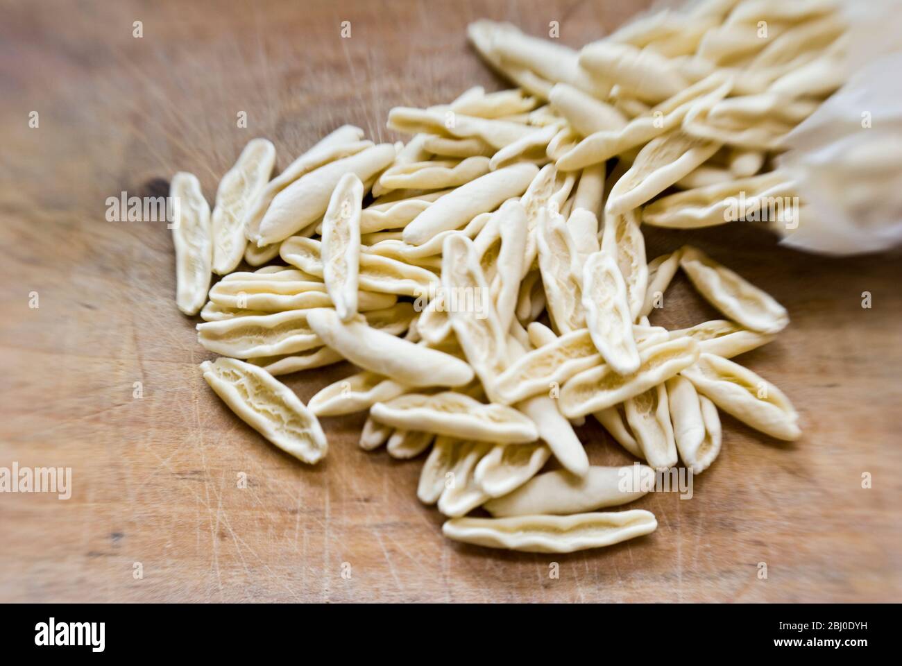 Raw cicatelli pasta shapes on wooden surface Stock Photo - Alamy