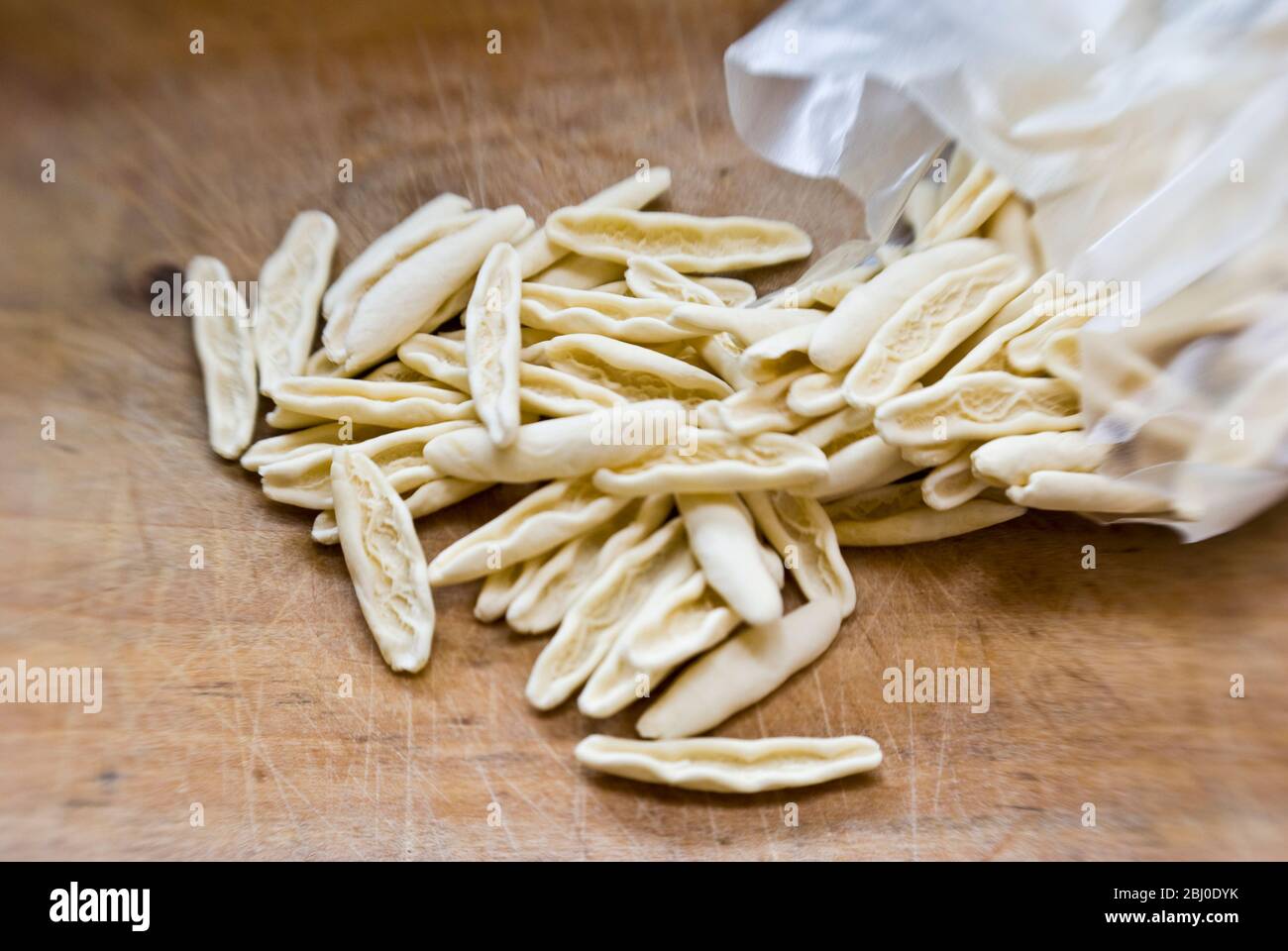 Raw cicatelli pasta shapes on wooden surface Stock Photo - Alamy