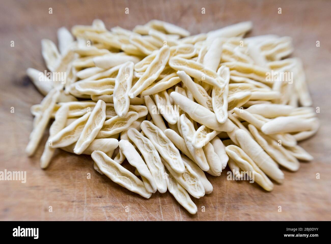 Raw cicatelli pasta shapes on wooden surface Stock Photo - Alamy