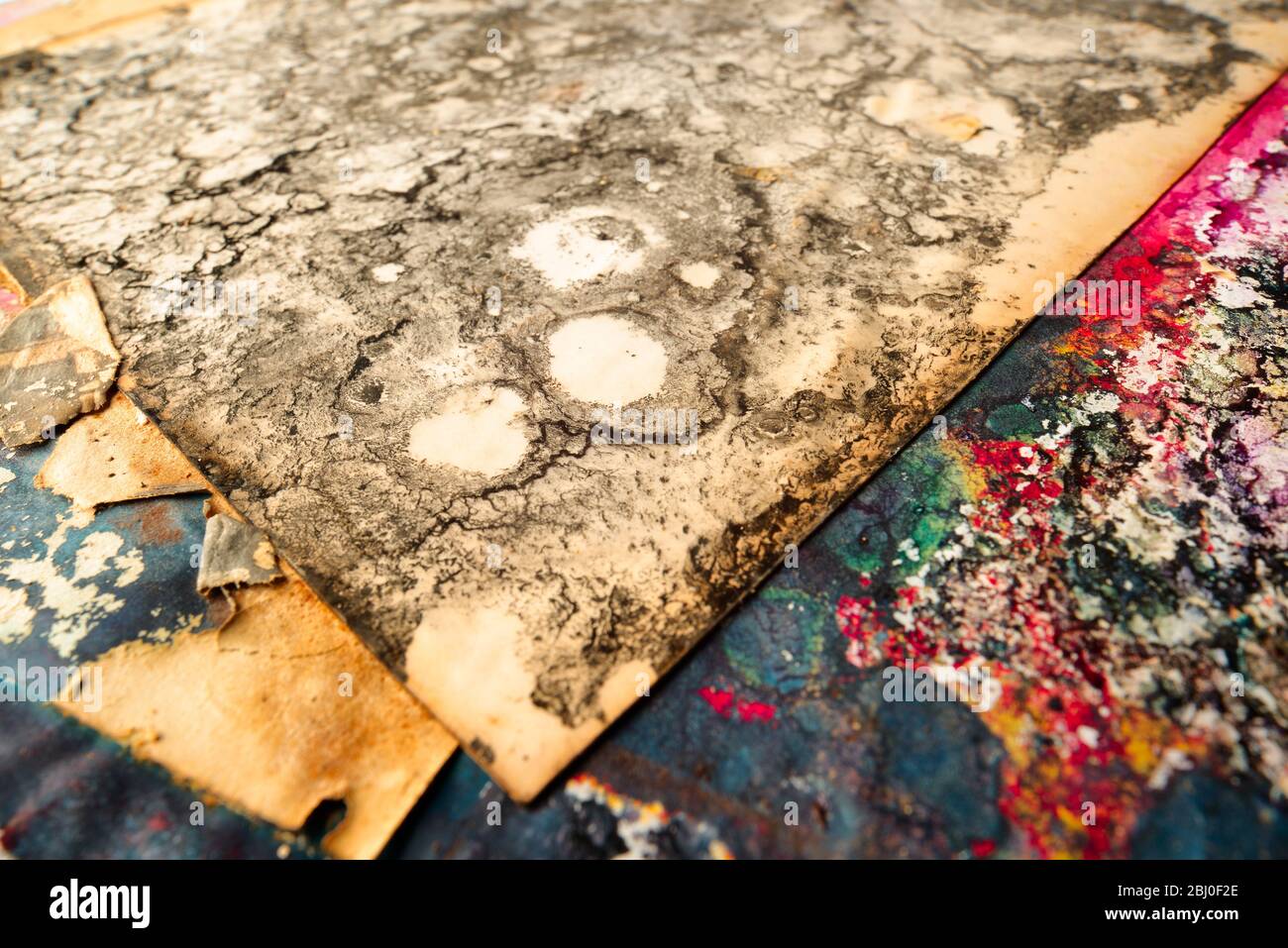 Sheets of paper damaged by chemicals. Corrosive acid-alkaline corrosive ...