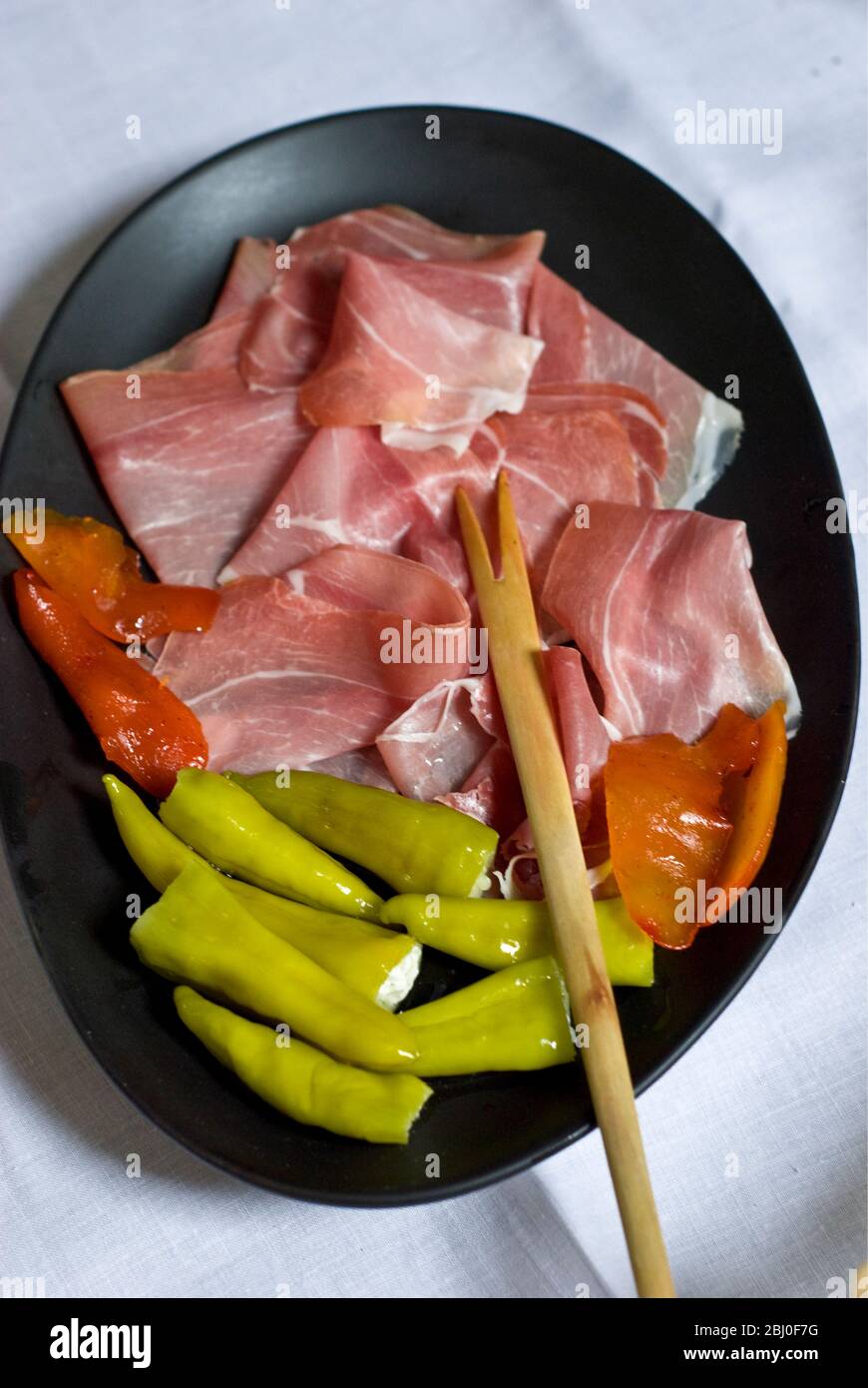 Spanish Serano dried ham with stuffed, green, chilli peppers and ...