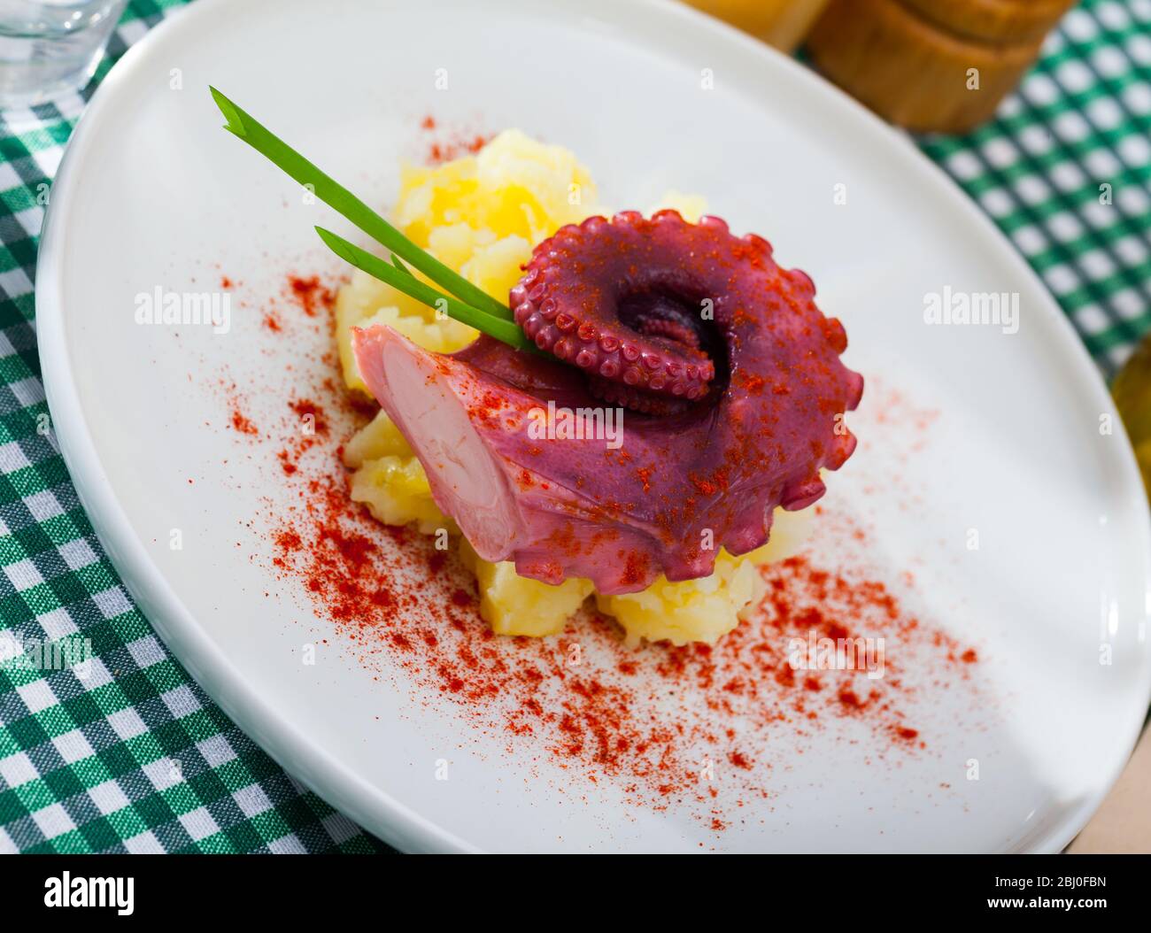 Seafood. Baked octopus tentacle served with boiled potatoes with ...