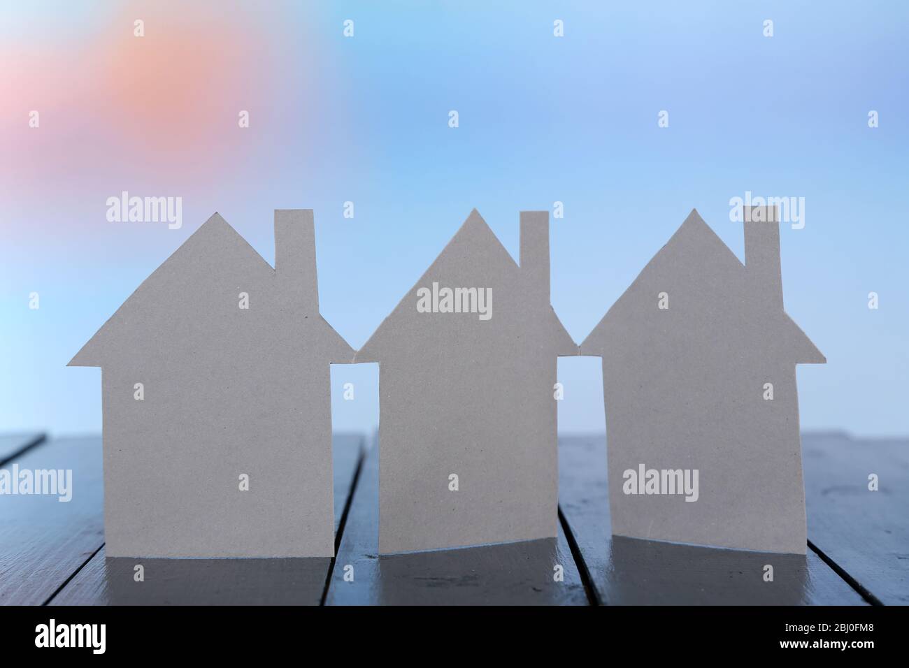 Paper houses on bright background Stock Photo - Alamy