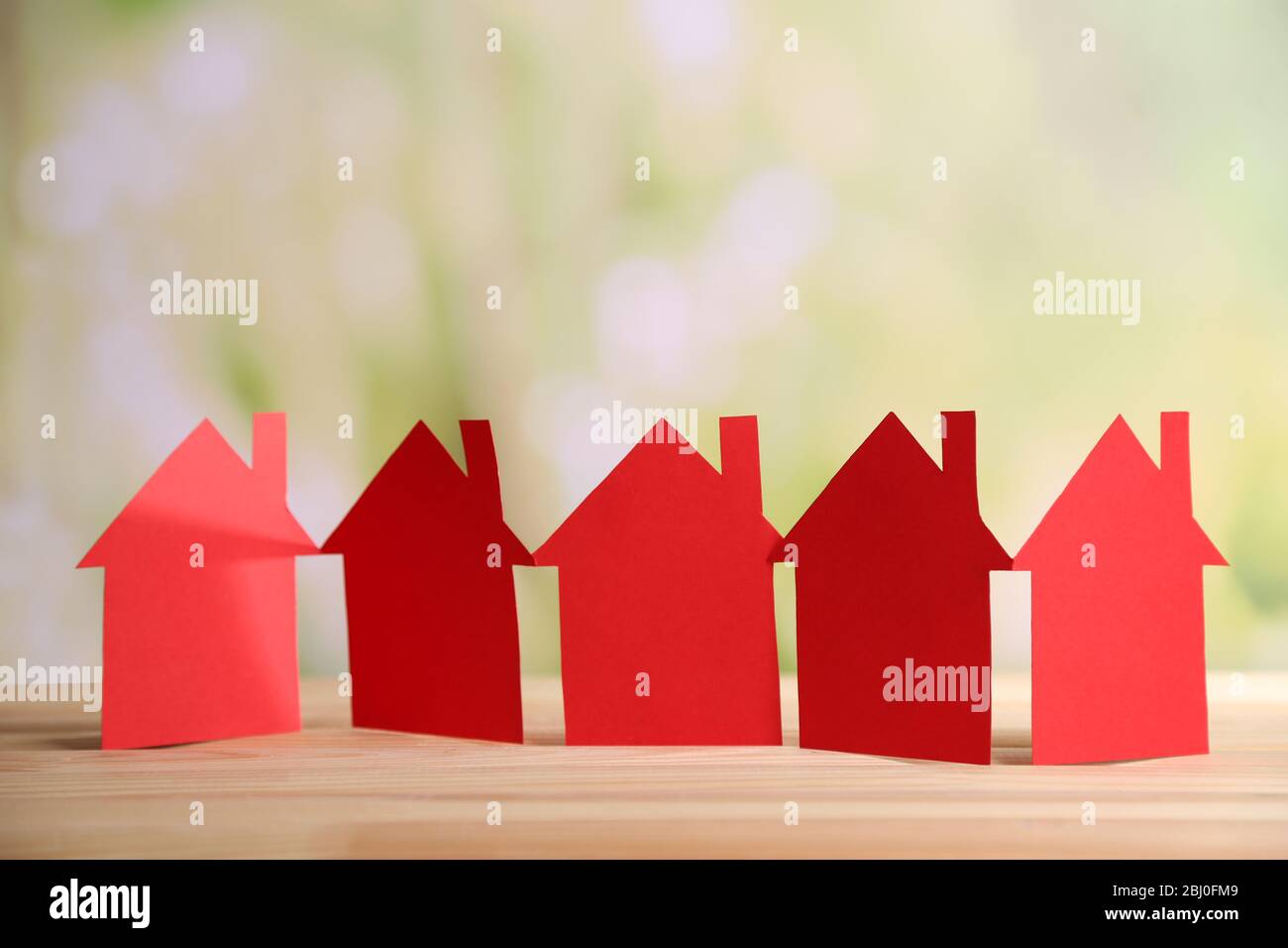Paper houses on bright background Stock Photo - Alamy