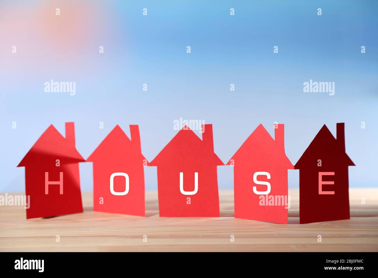 Paper houses on bright background Stock Photo - Alamy