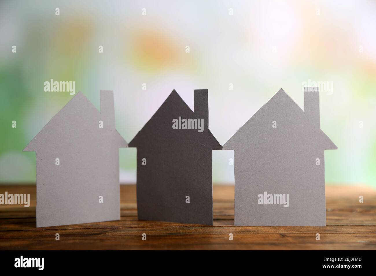 Paper houses on bright background Stock Photo - Alamy