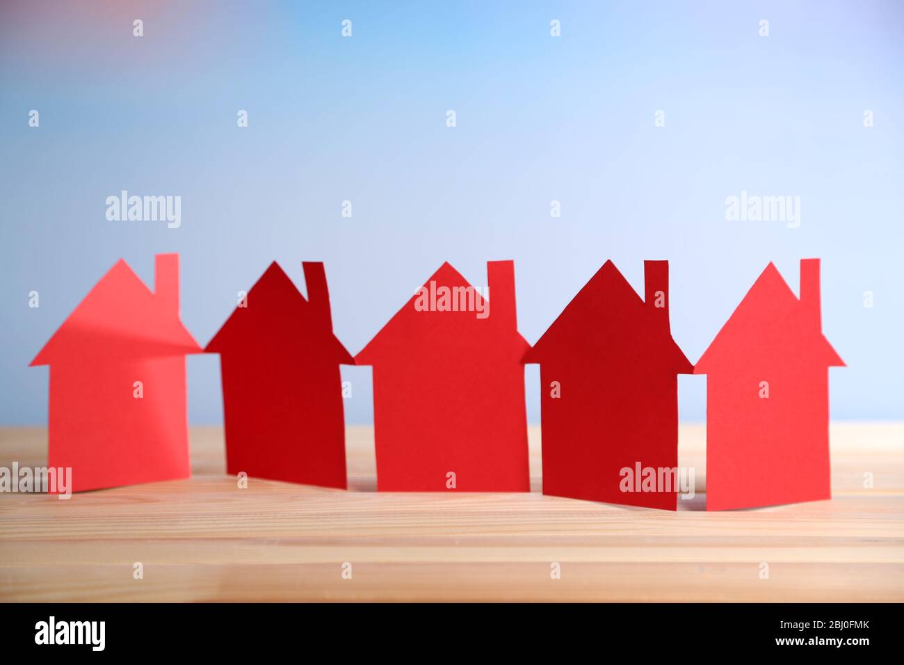 Paper houses on bright background Stock Photo - Alamy