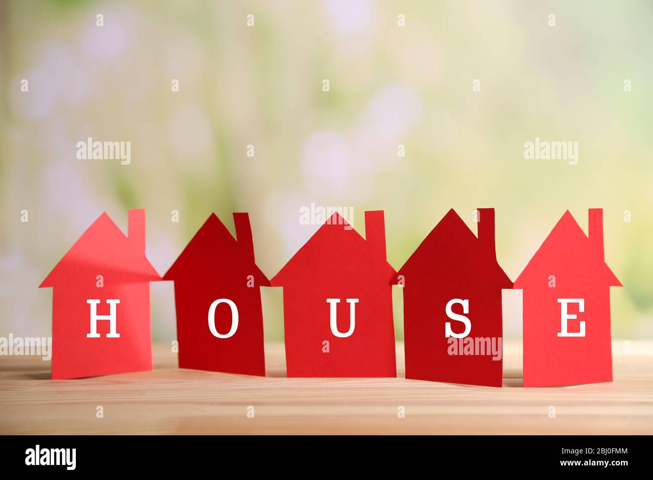 Paper houses on bright background Stock Photo - Alamy