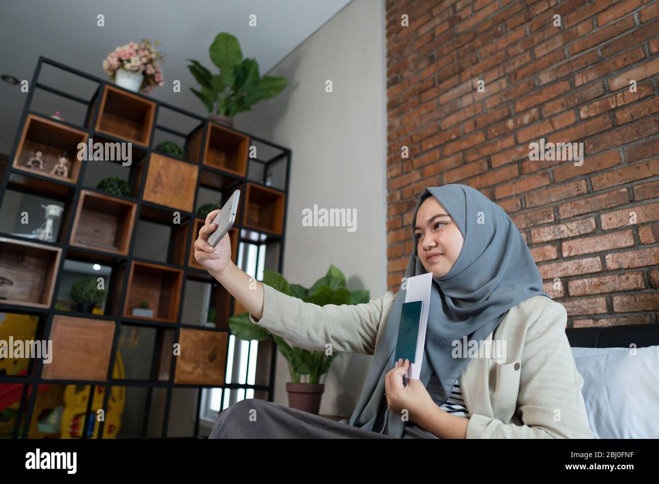 muslim young woman selfie with holding a passport before going umrah ...