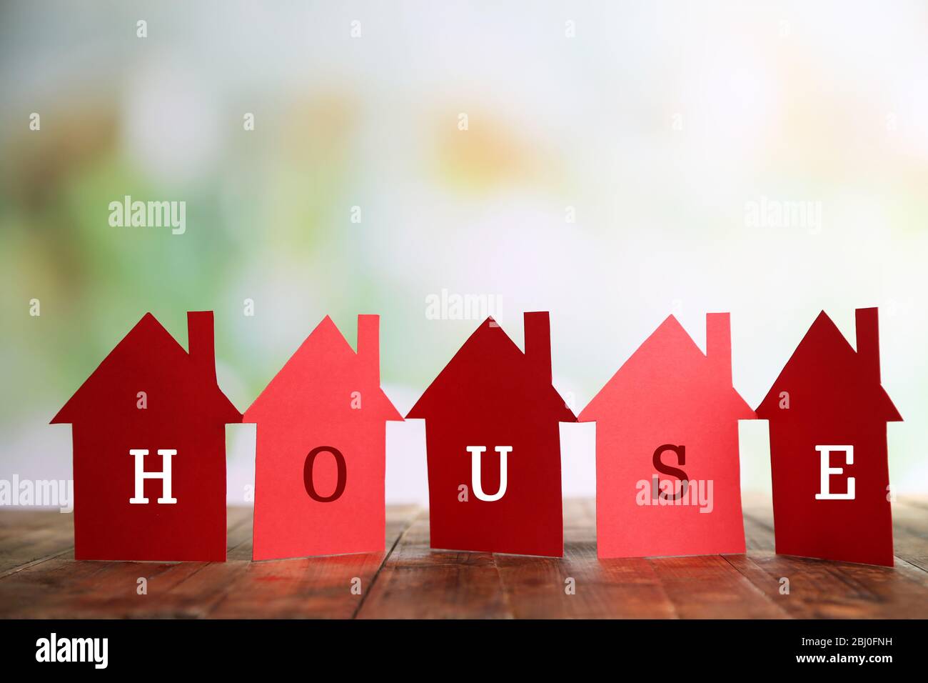 Paper houses on bright background Stock Photo - Alamy