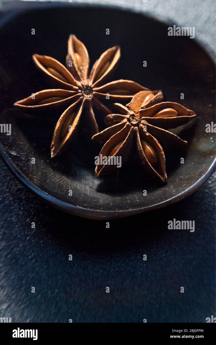Dried Star anise fruits in small bowl. Also known as star aniseed ...