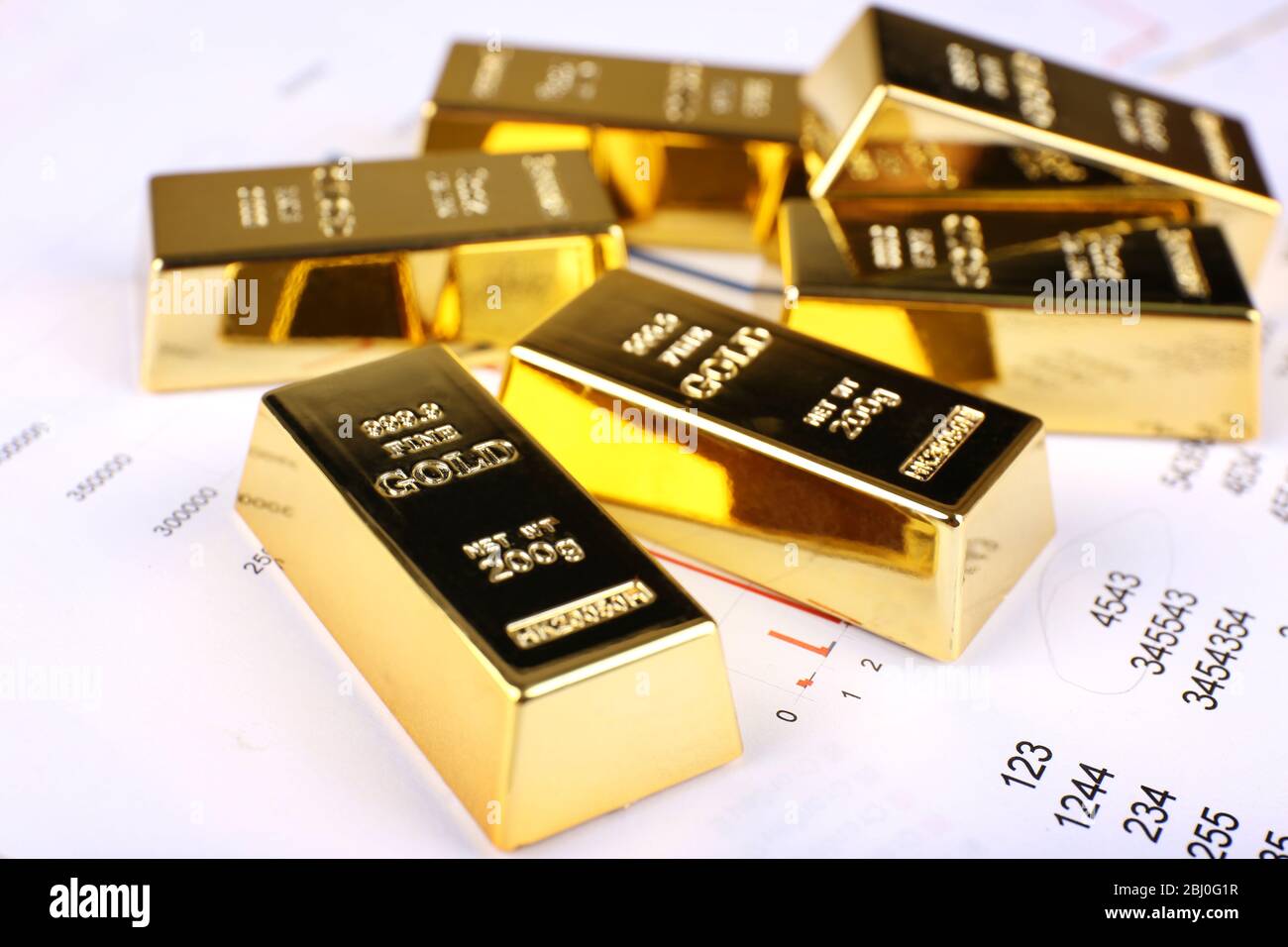 Gold bullion on documents background Stock Photo - Alamy