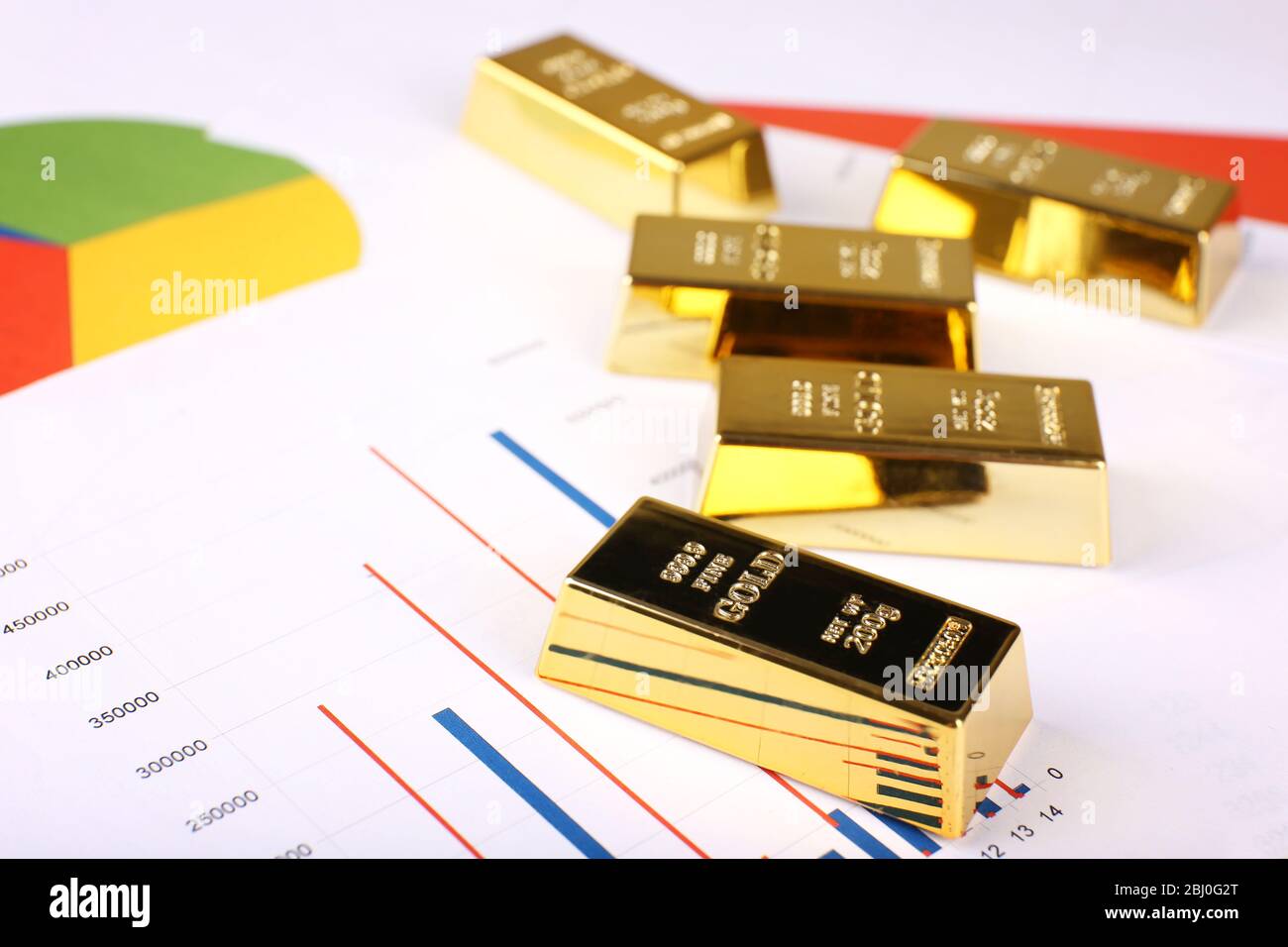 Gold bullion on documents background Stock Photo - Alamy